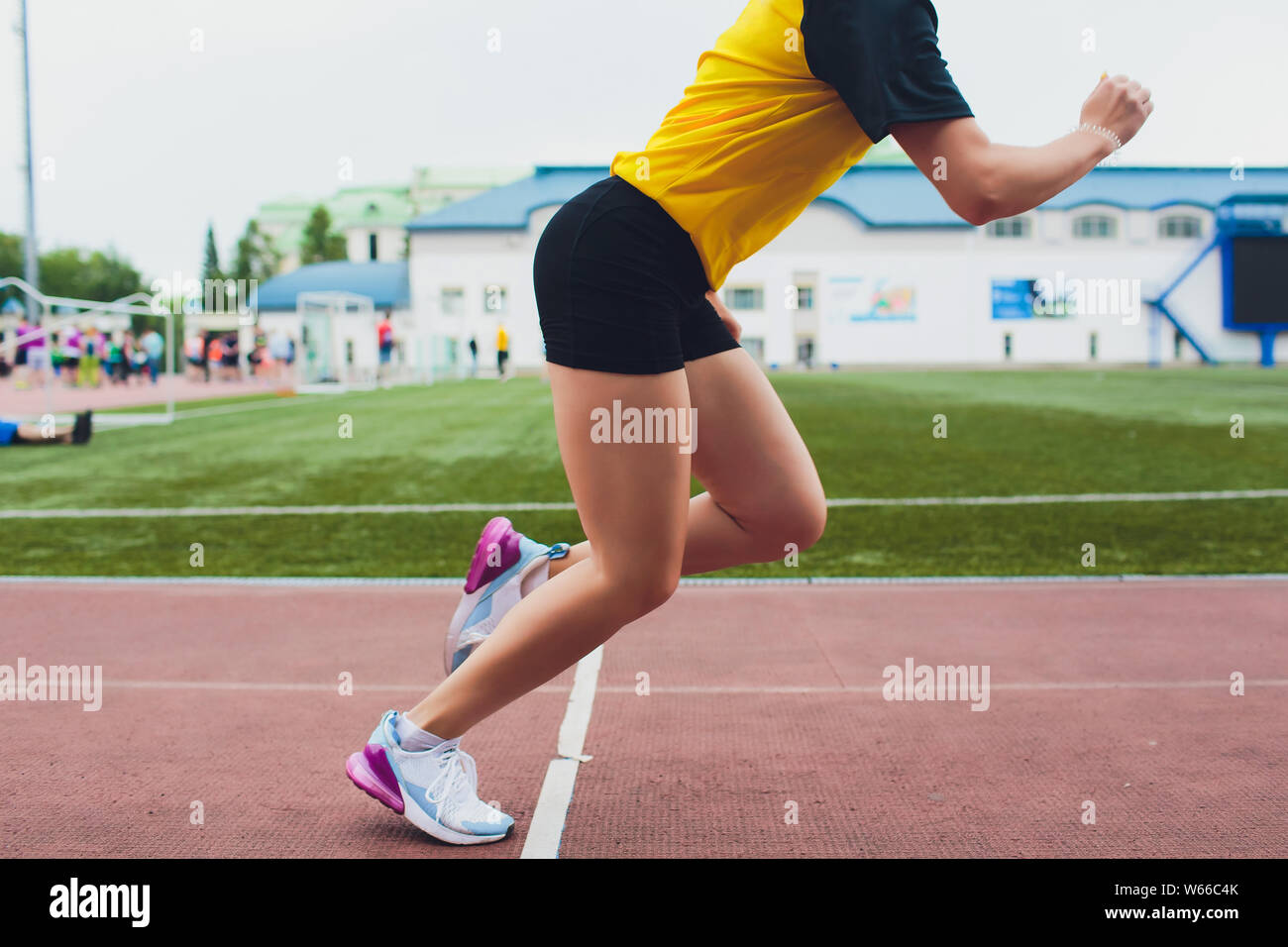 Cropped shot of young female athlete launching off the start line in a ...