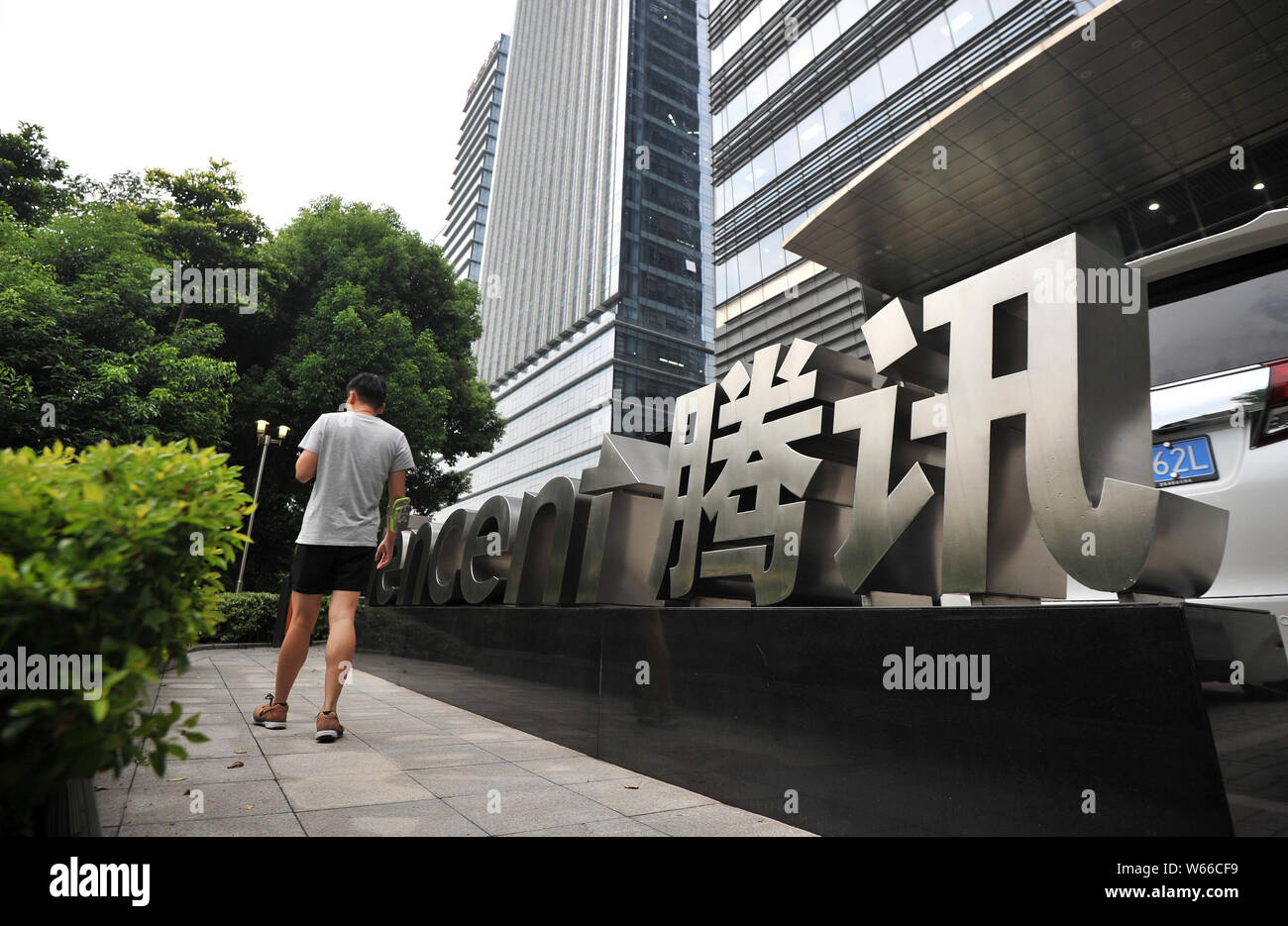 --FILE--A pedestrian walks past the headquarters building of Tencent in ...