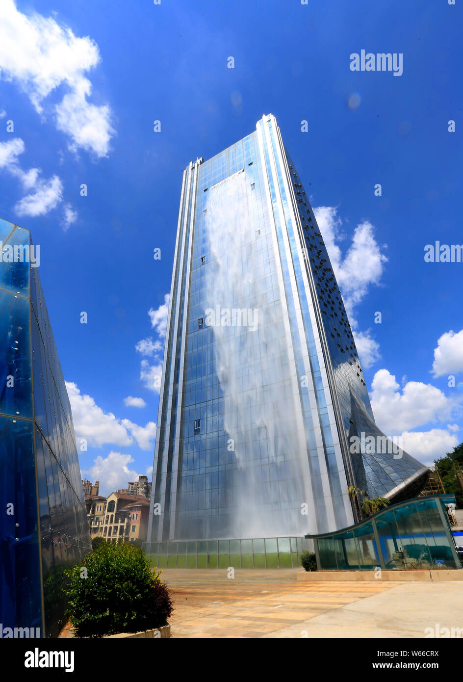 View of an artificial waterfall on the exterior of a 121-meter-tall ...