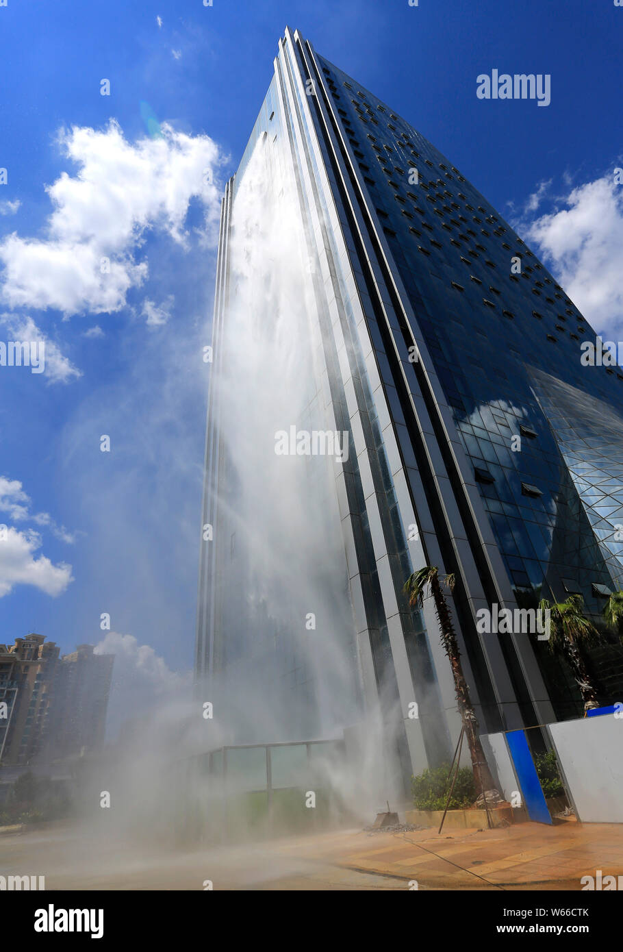 View of an artificial waterfall on the exterior of a 121-meter-tall ...