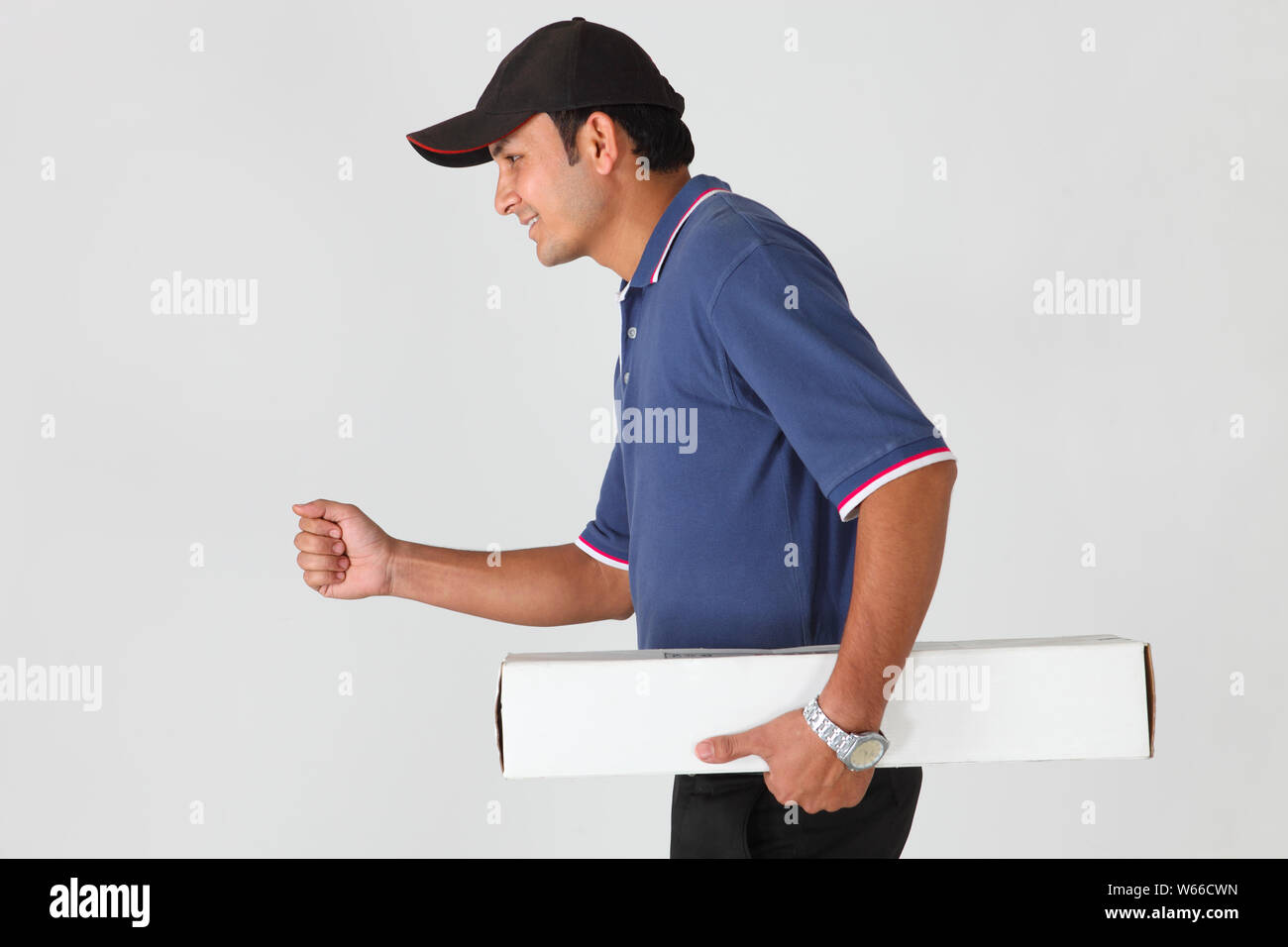 Delivery man delivering a cardboard box Stock Photo - Alamy