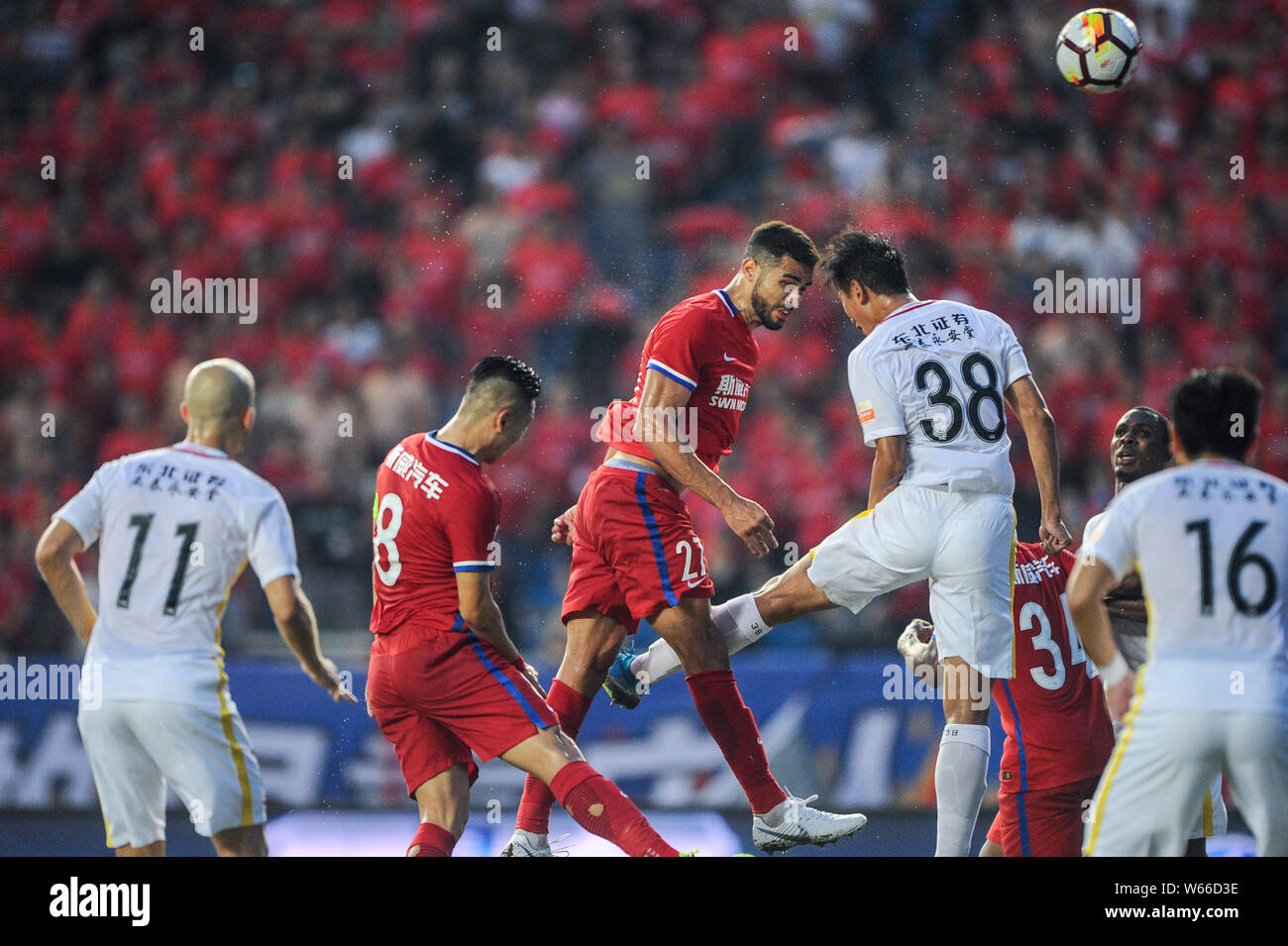 Brazilian football player Alan Kardec of Chongqing SWM, left, heads the ...