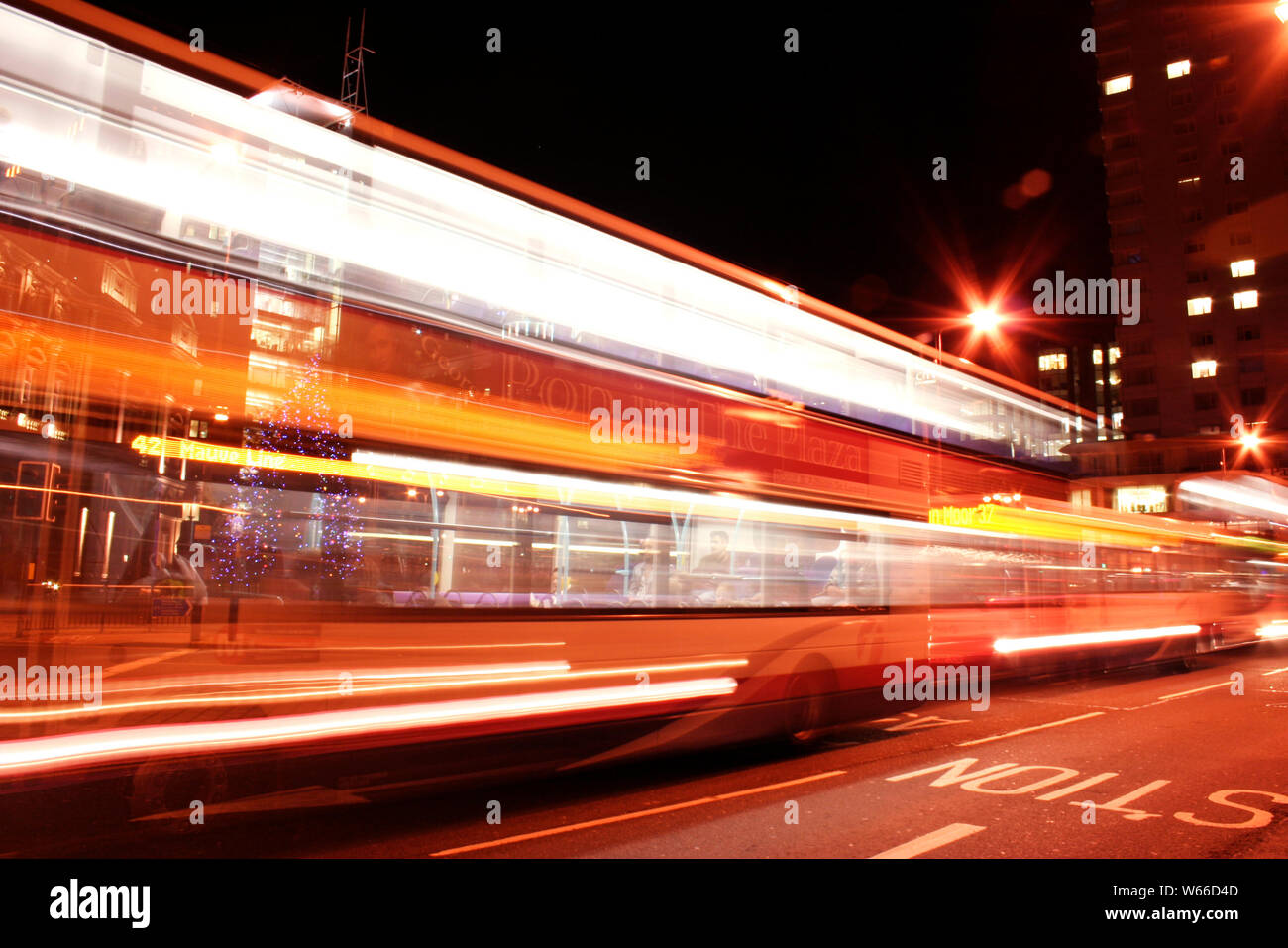 Buses driving through Leeds City centre at night Stock Photo - Alamy