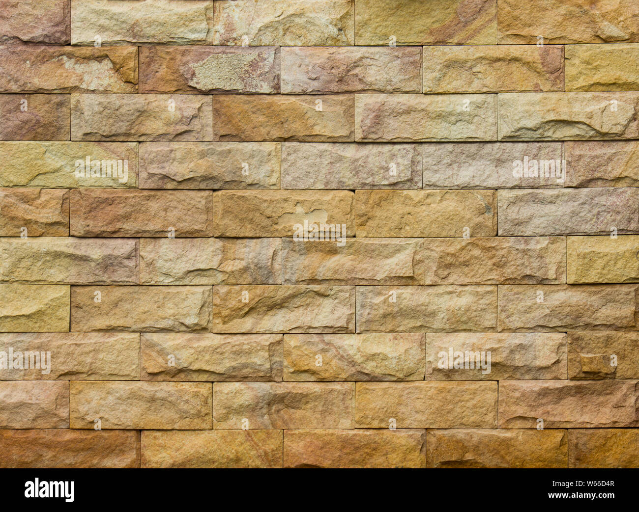 Detail of yellow rough stone brick background Stock Photo - Alamy