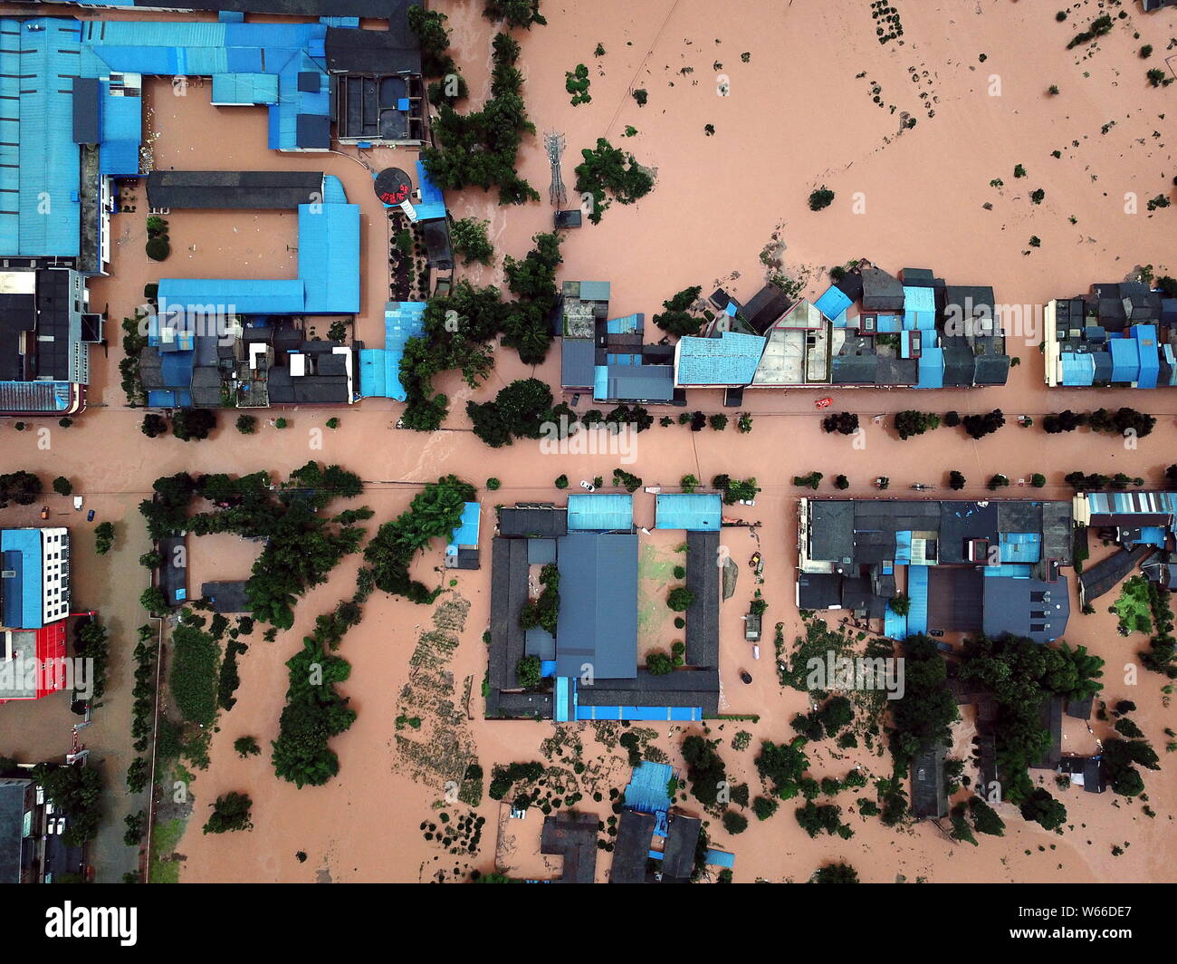 An aerial view of residential houses and fields submerged by floodwater ...
