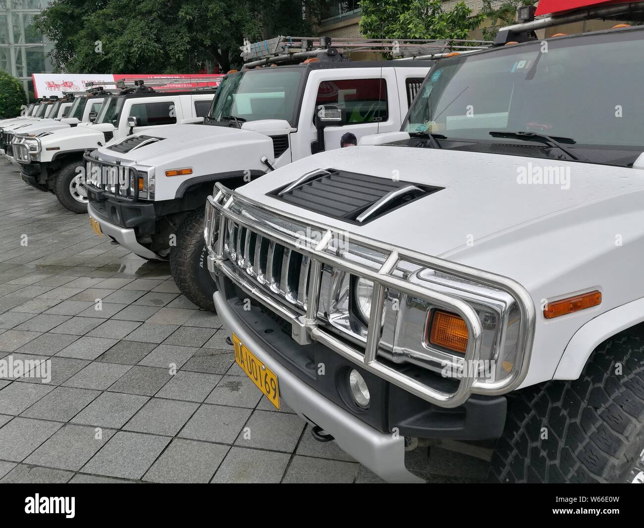 Extended edition Hummer SUVs are lined up in front of an exhibition ...