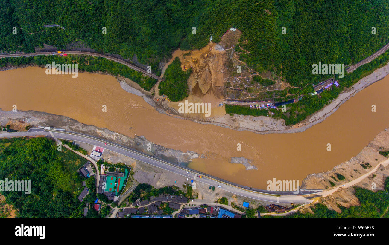 Chinese rescuers clear away mud and stones after the Lueyang section of ...