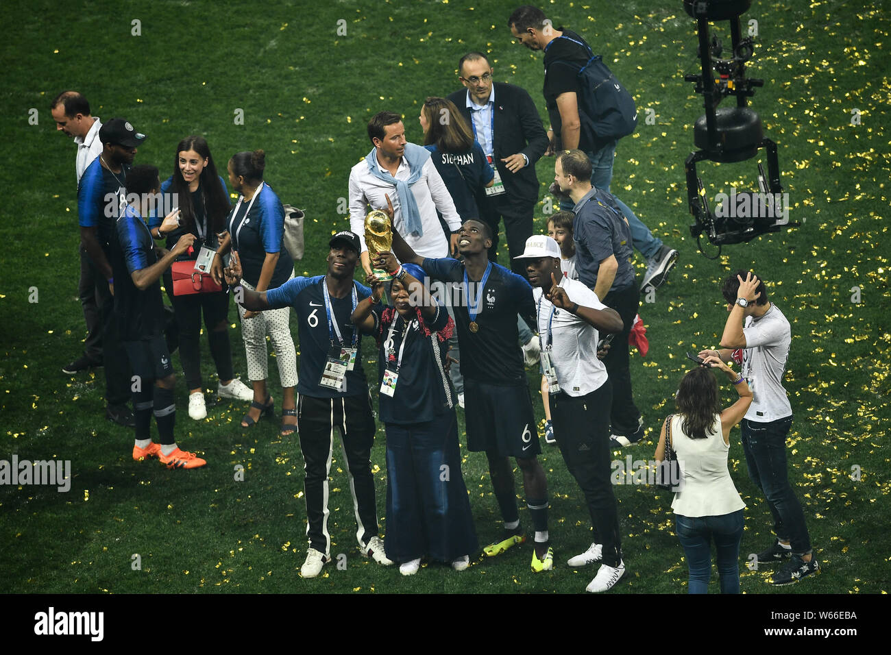 Paul Pogba of France poses with the World Cup trophy with his family ...
