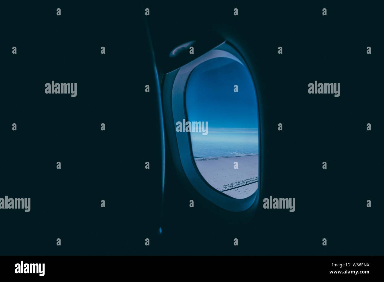 Window of the airplane with the view of the wing and blue sky Stock ...