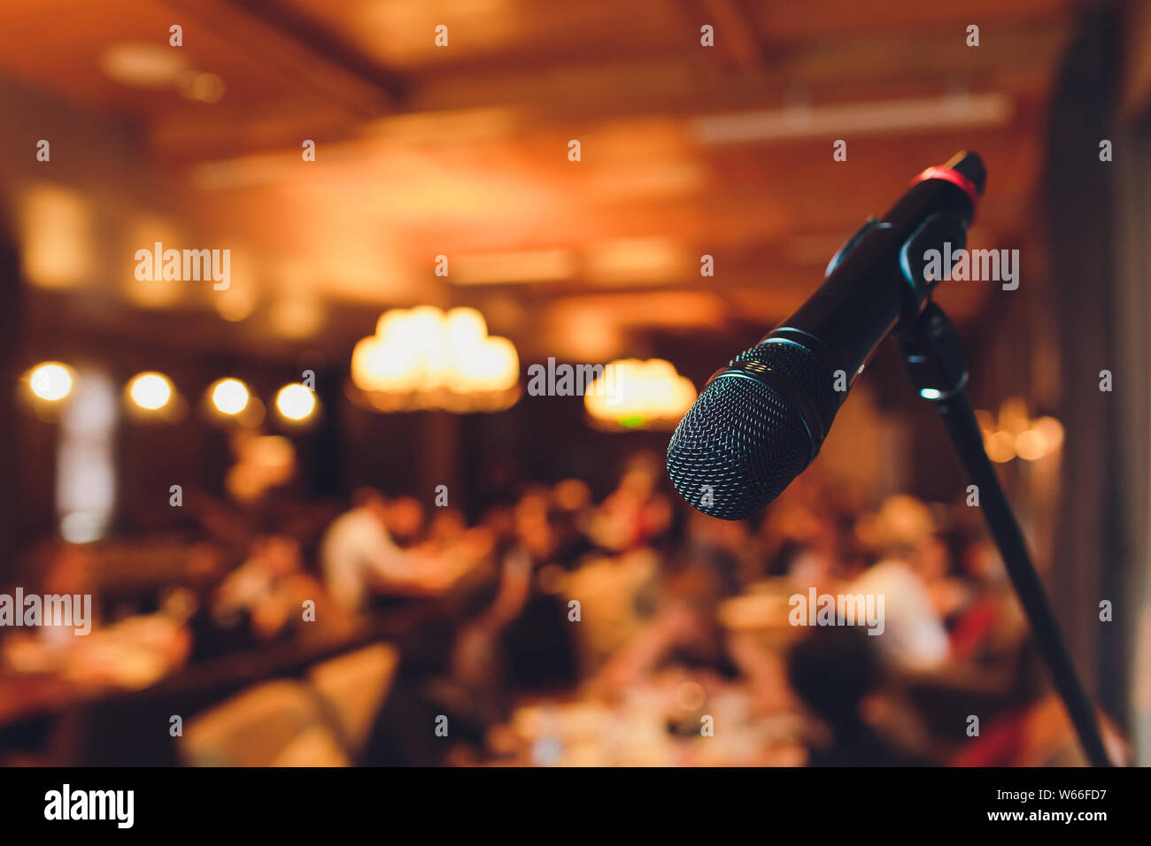 Microphone on stage against a background of auditorium Stock Photo - Alamy
