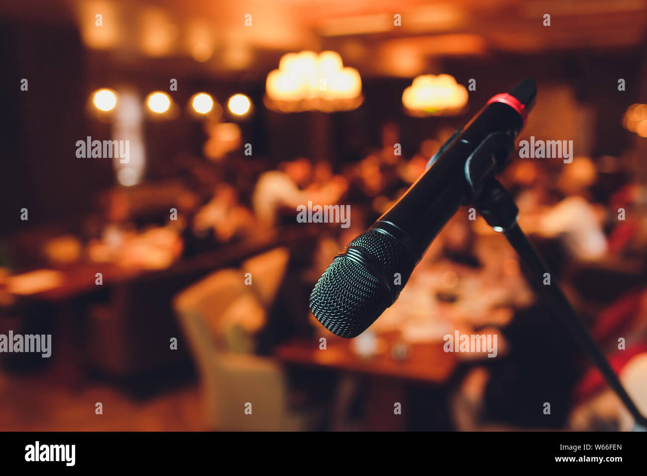 Microphone on stage against a background of auditorium Stock Photo - Alamy