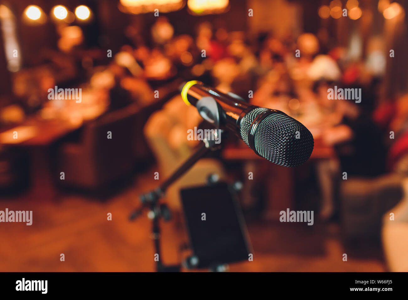 Microphone on stage against a background of auditorium Stock Photo - Alamy
