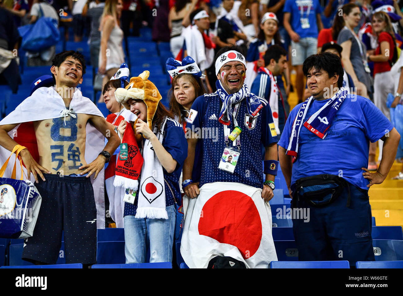 Heartbroken Japanese fans weep after Japan was defeated by Belgium in the Round of 16 match ...