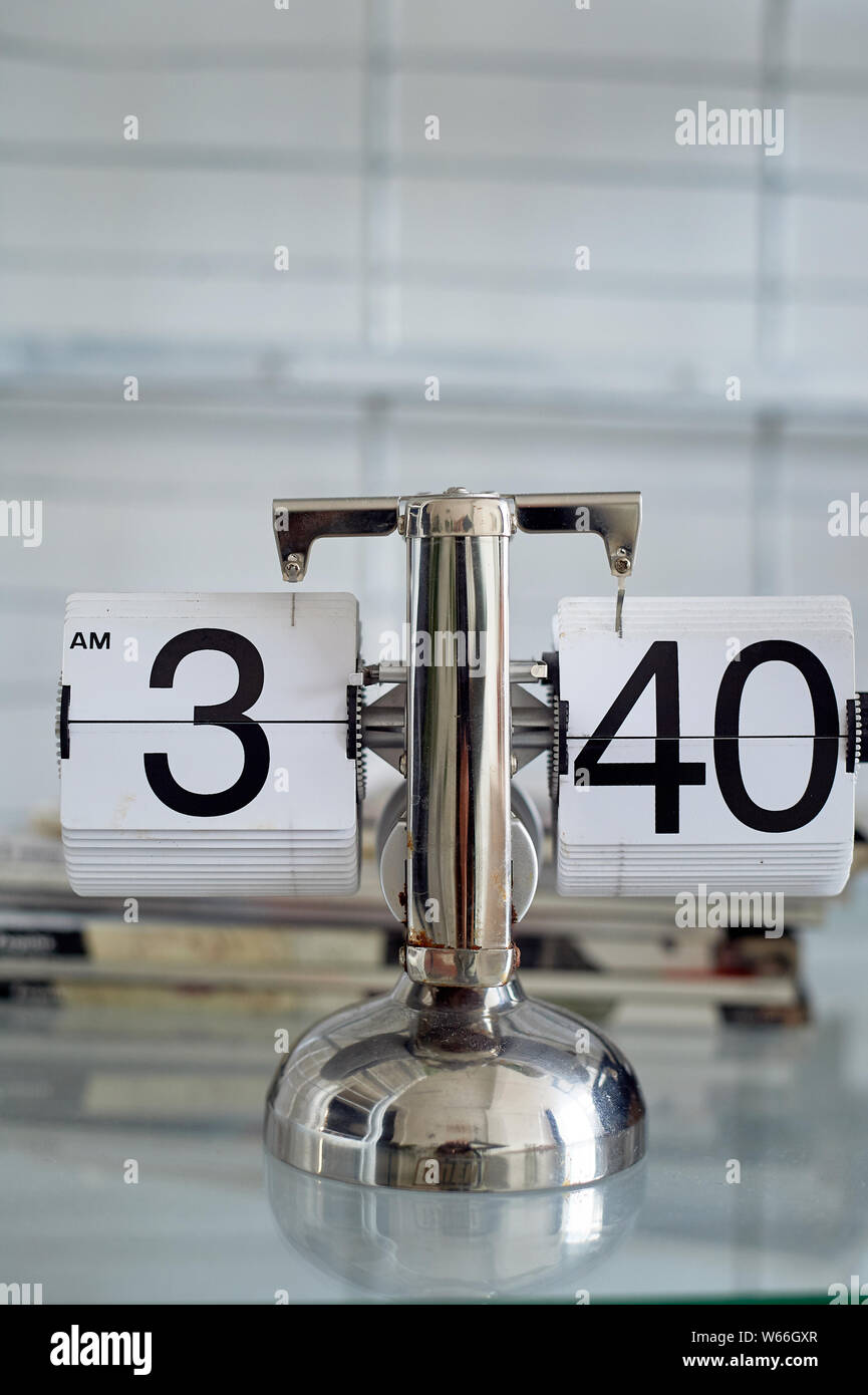 Classic flip clock on a metal stand in the interior.The theme of time ...