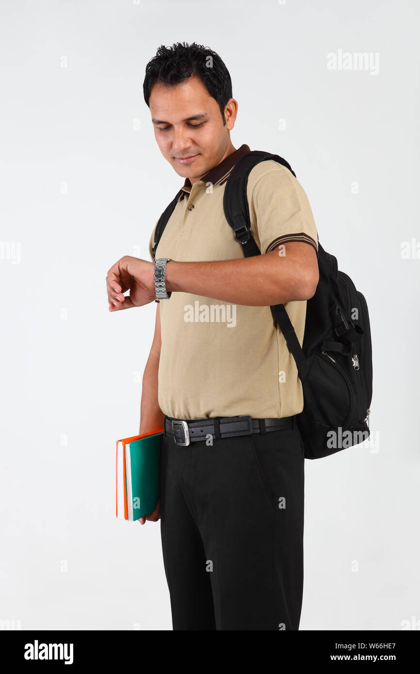 Student looking at wristwatch hi-res stock photography and images - Alamy