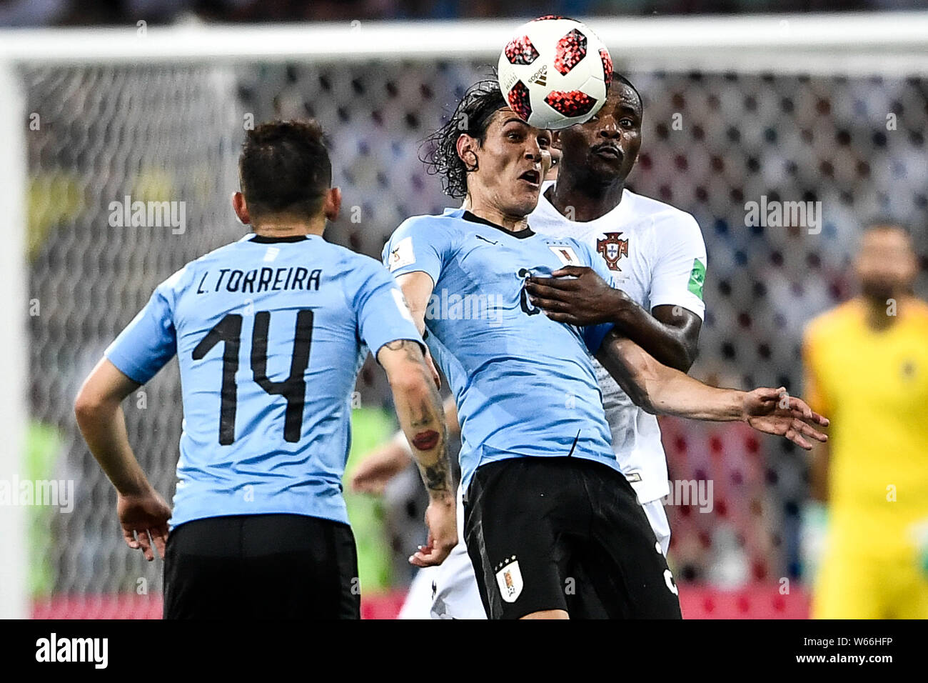 Edinson Cavani of Uruguay, center, heads the ball against Portugal in ...