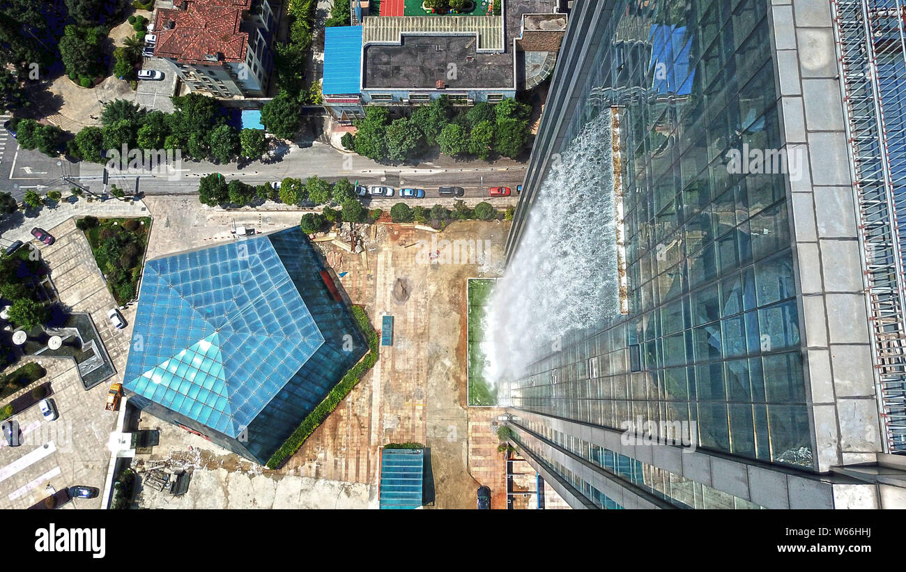 View of an artificial waterfall on the exterior of a 121-meter-tall ...