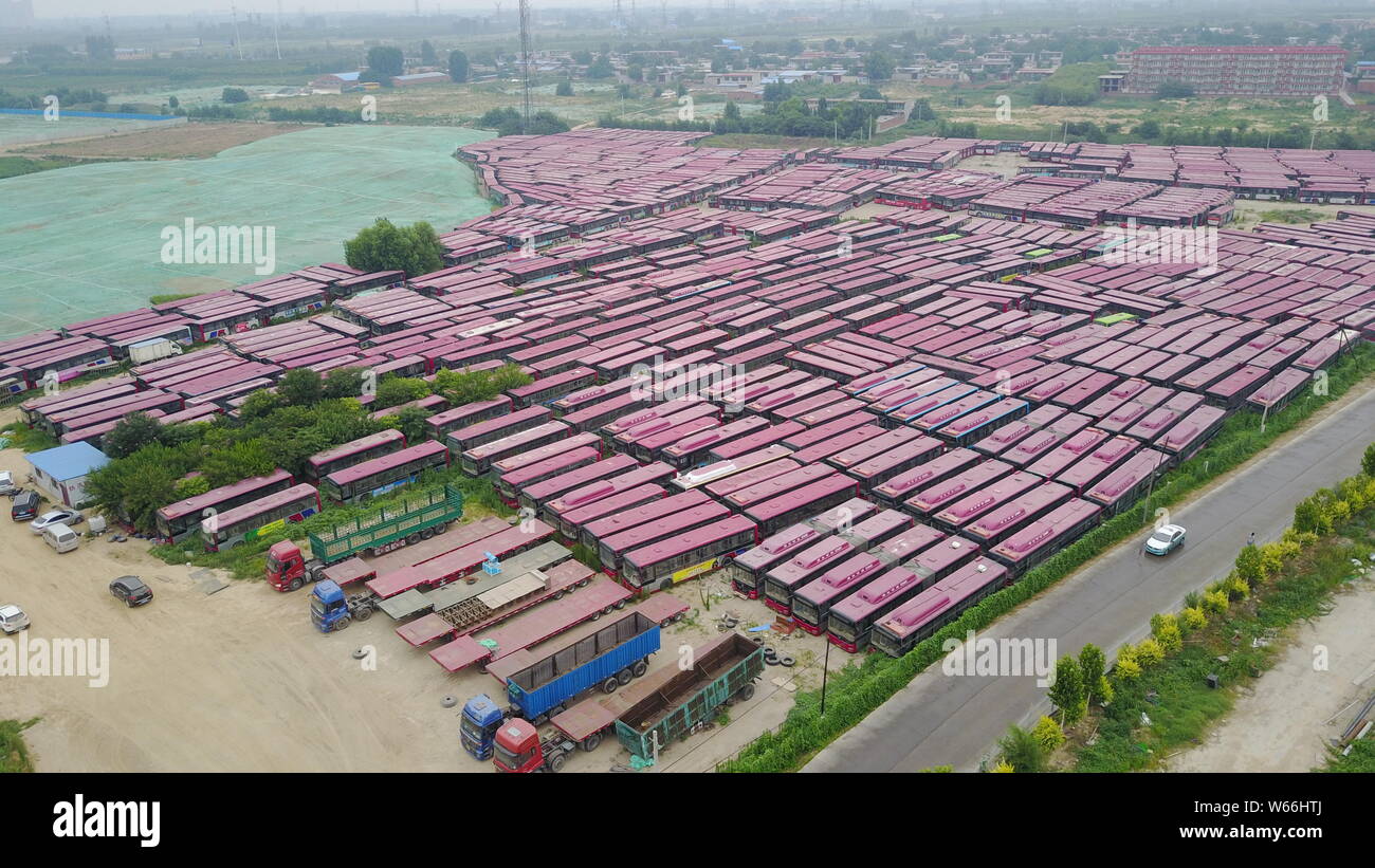 An aerial view of a bus "graveyard" crammed with discarded buses in an ...
