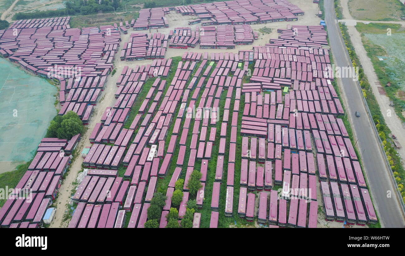 An aerial view of a bus "graveyard" crammed with discarded buses in an ...