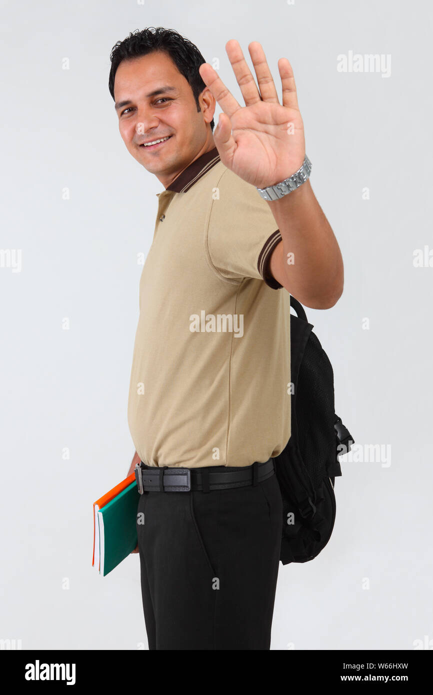 College student waving hand Stock Photo - Alamy