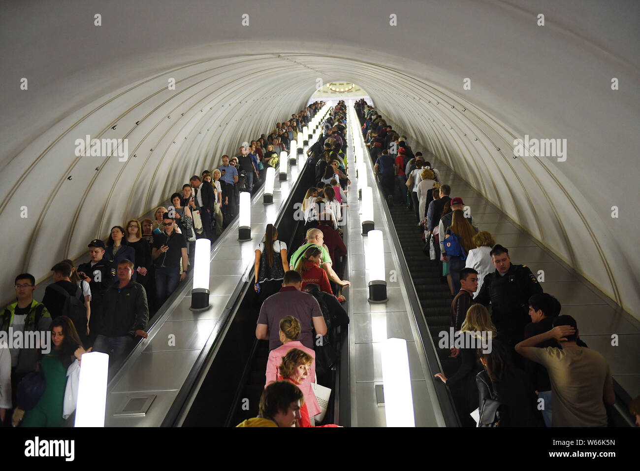 Commuters take escalators in a subway station of the Moscow Metro in ...
