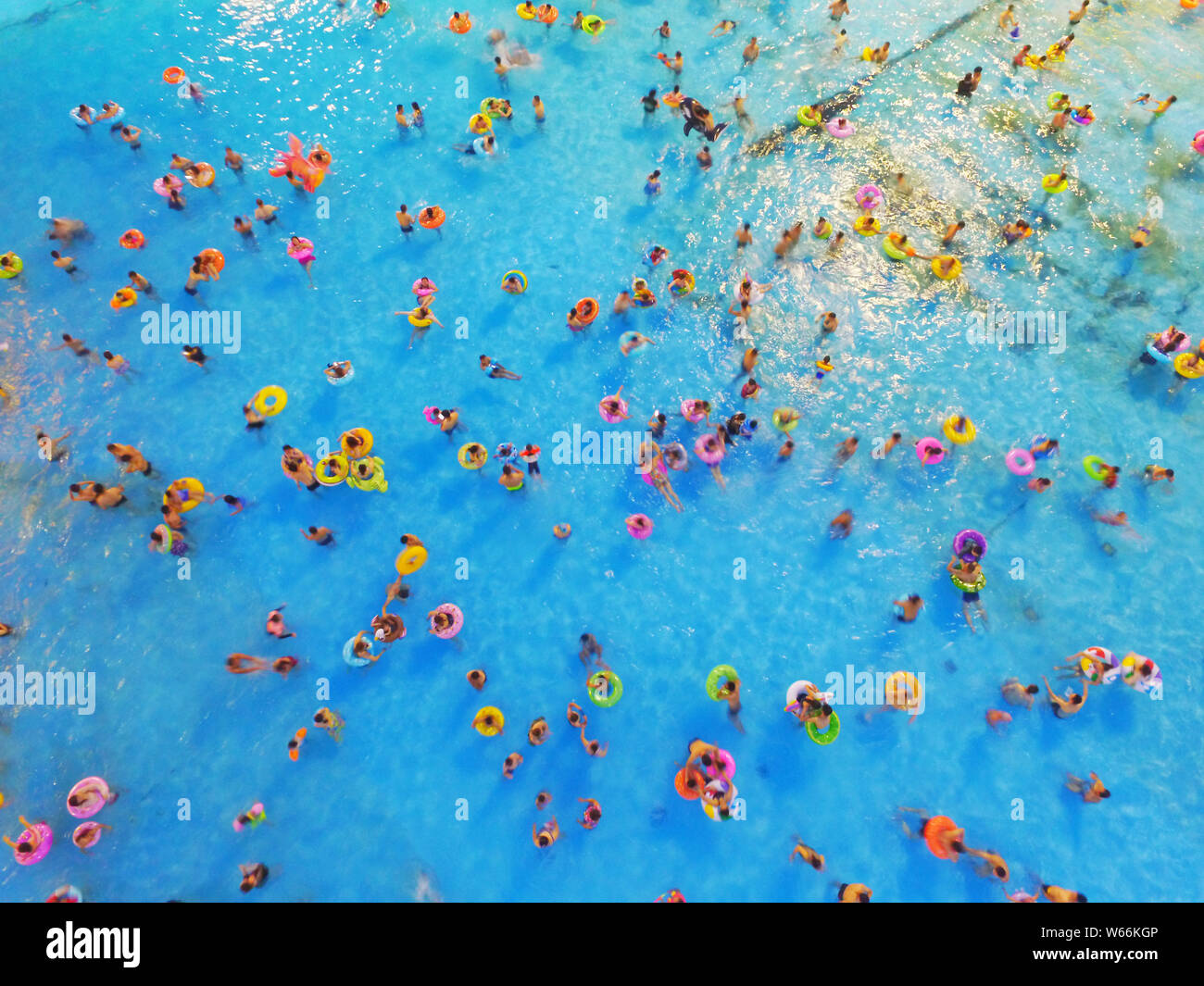 Chinese holidaymakers crowd a water park to cool off on a scorching day ...