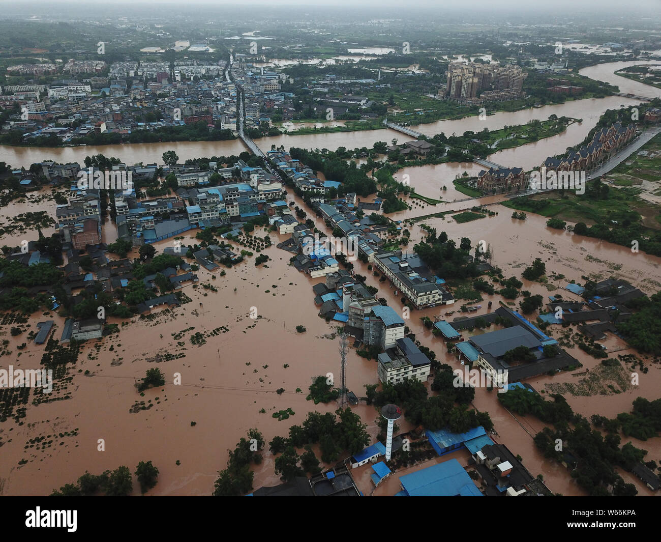 An aerial view of residential houses and fields submerged by floodwater ...