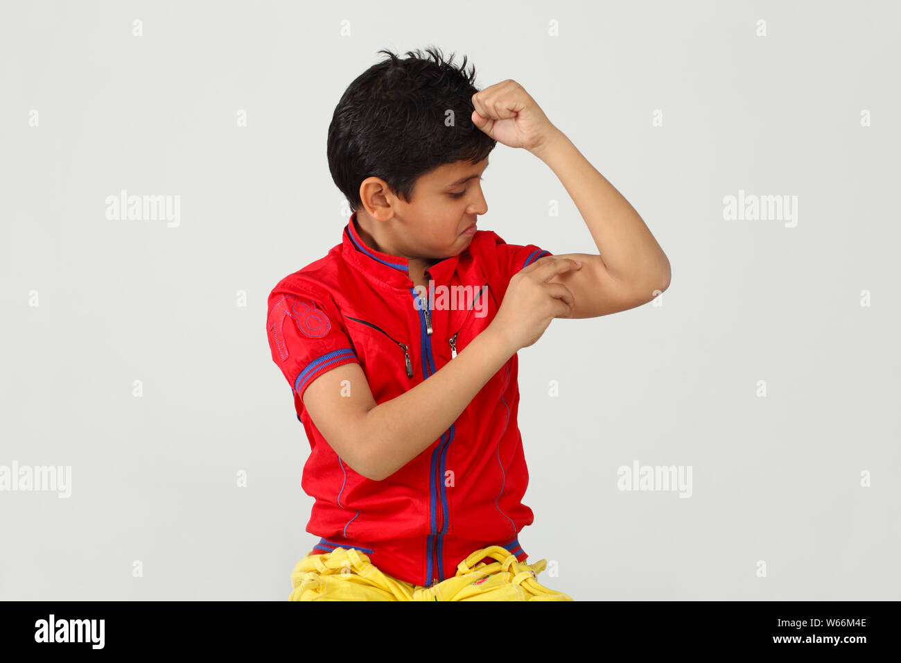 Boy flexing muscles Stock Photo - Alamy