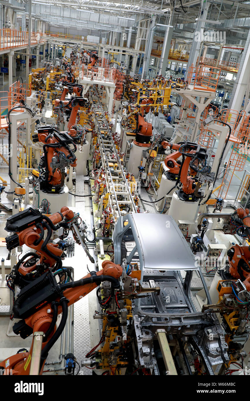Cars are being assembled on the assembly line at the auto plant of ...