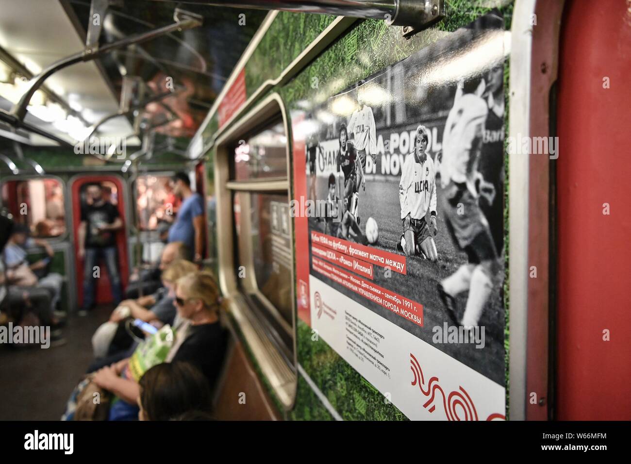 Passengers and football fans take a subway train specially fitted with ...