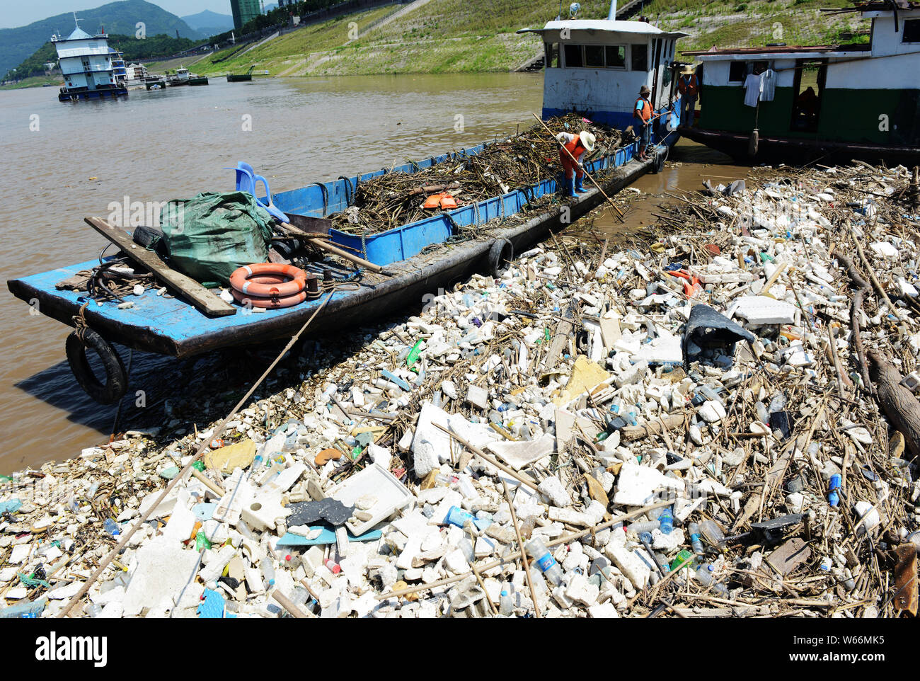 Chinese workers collect garbage floating on the Yangtze River in ...