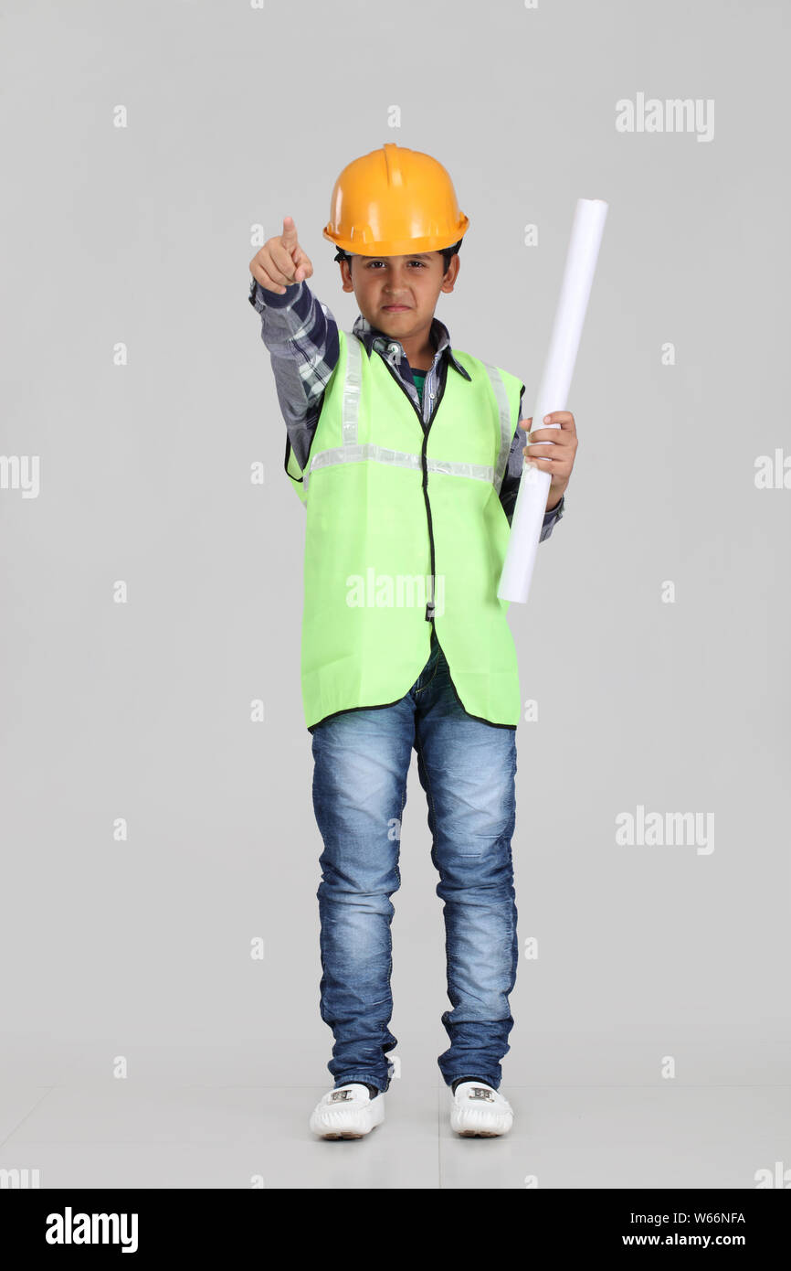 Boy pretending to be an architect and pointing Stock Photo - Alamy