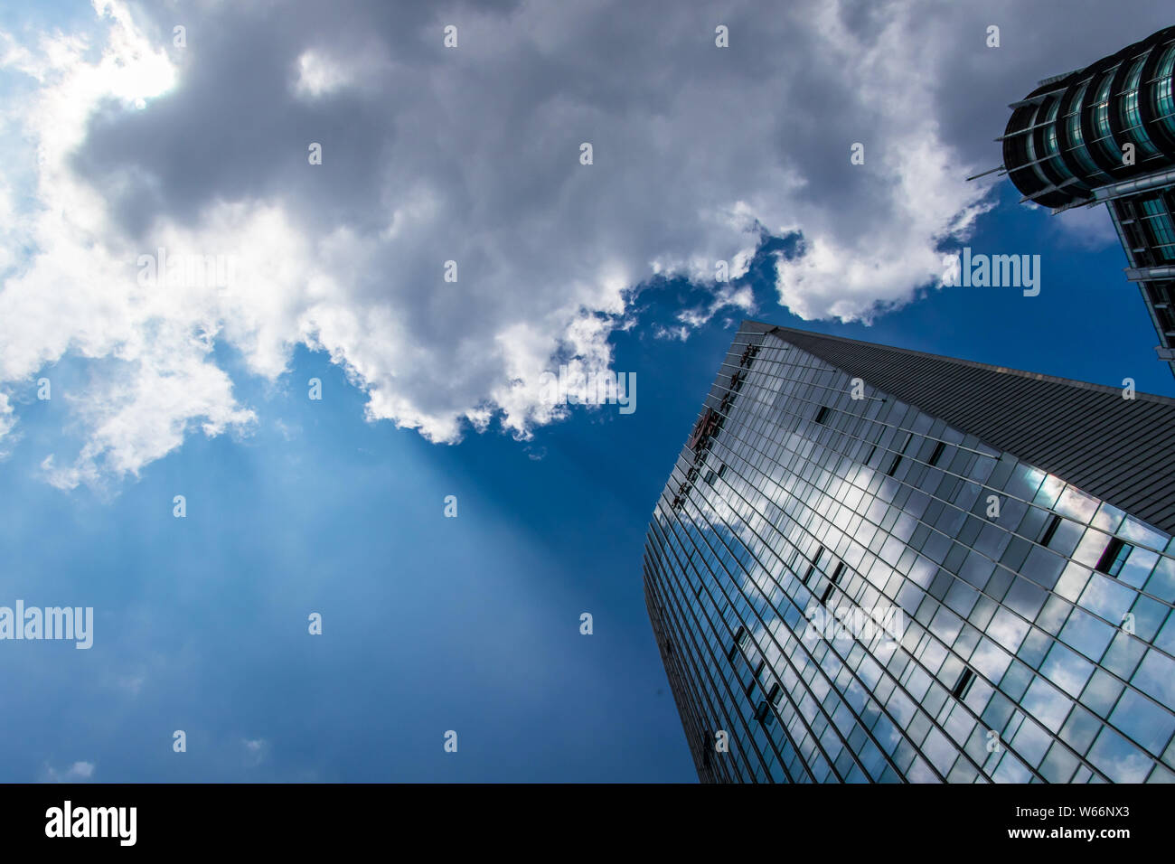 A worm's eye view of white clouds with Tyndall effect and shadows in ...