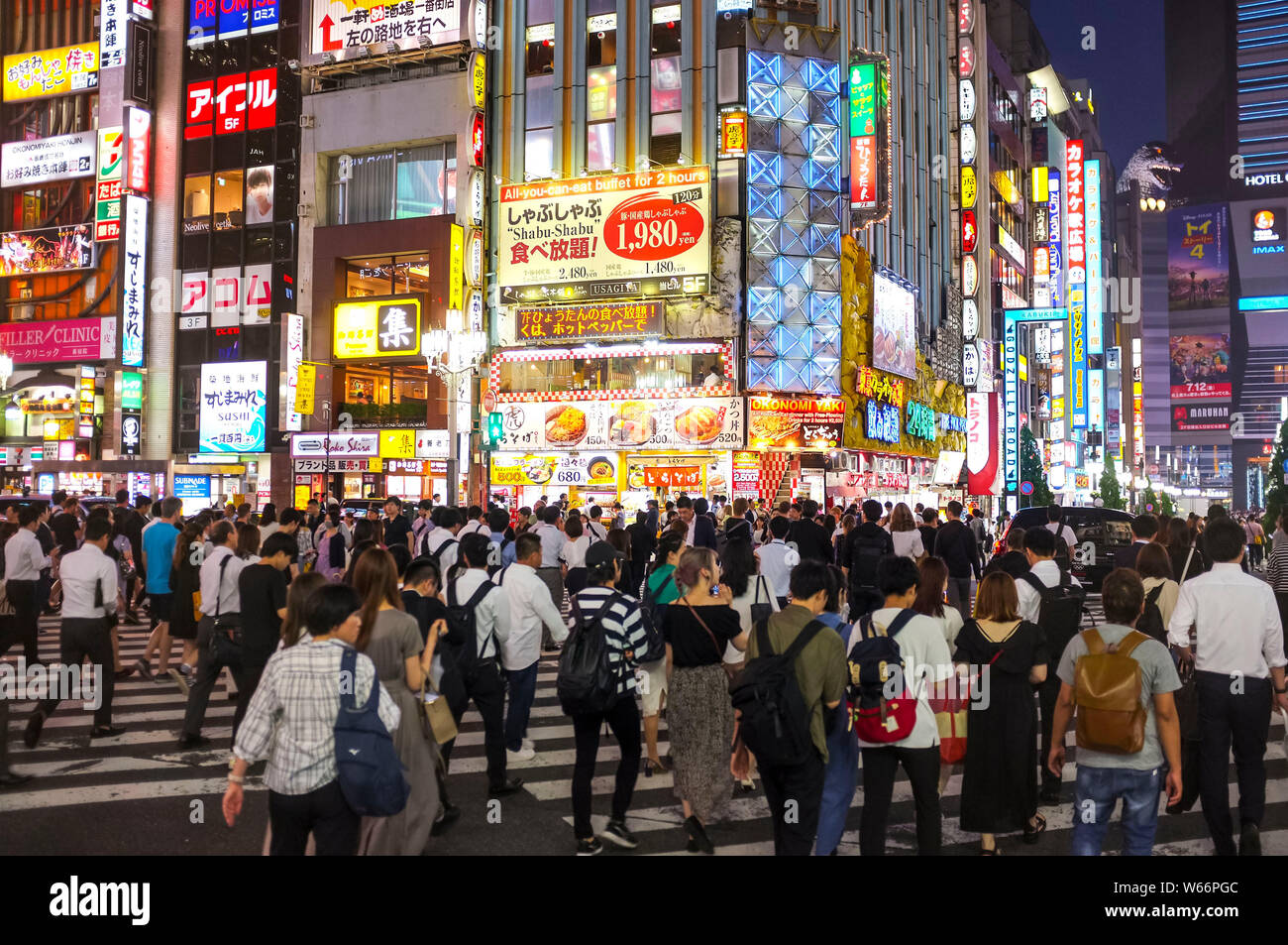 People crossing the street in Shinjuku, Godzilla road, Tokyo, Japan, at ...
