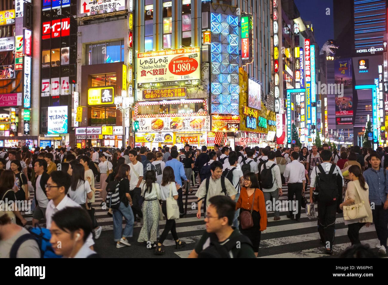 People crossing the street in Shinjuku, Godzilla road, Tokyo, Japan, at ...