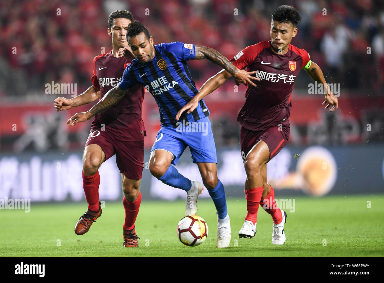 Brazilian football player Alex Teixeira of Jiangsu Suning, center ...