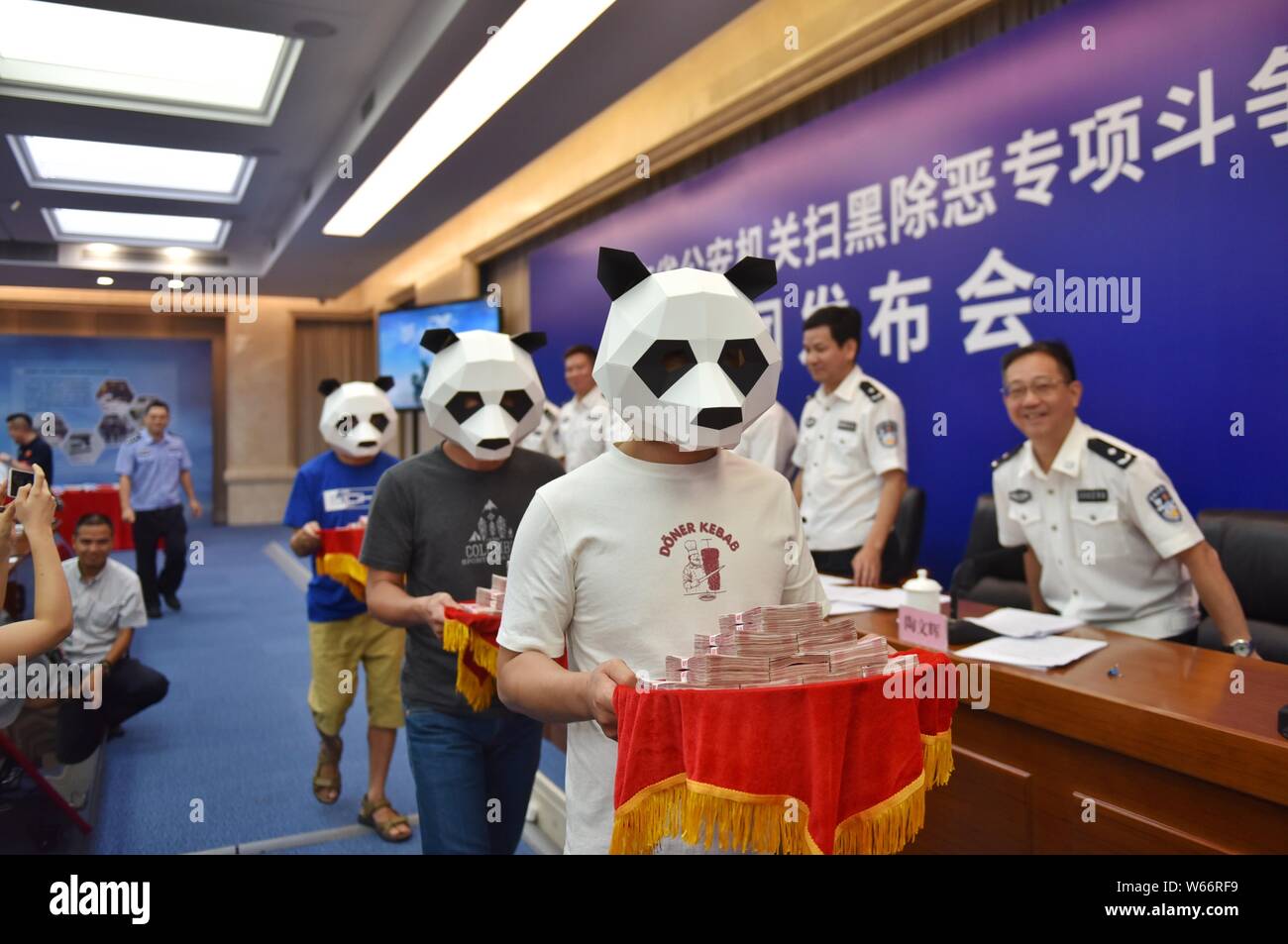 Three men with giant panda masks receive cash rewards for reporting ...