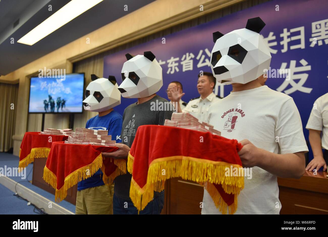 Three men with giant panda masks receive cash rewards for reporting ...