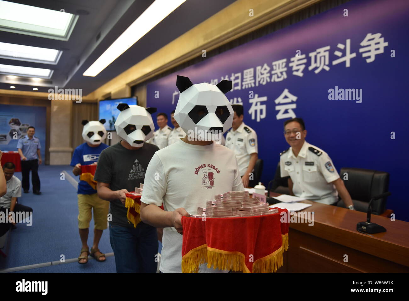 Three men with giant panda masks receive cash rewards for reporting ...