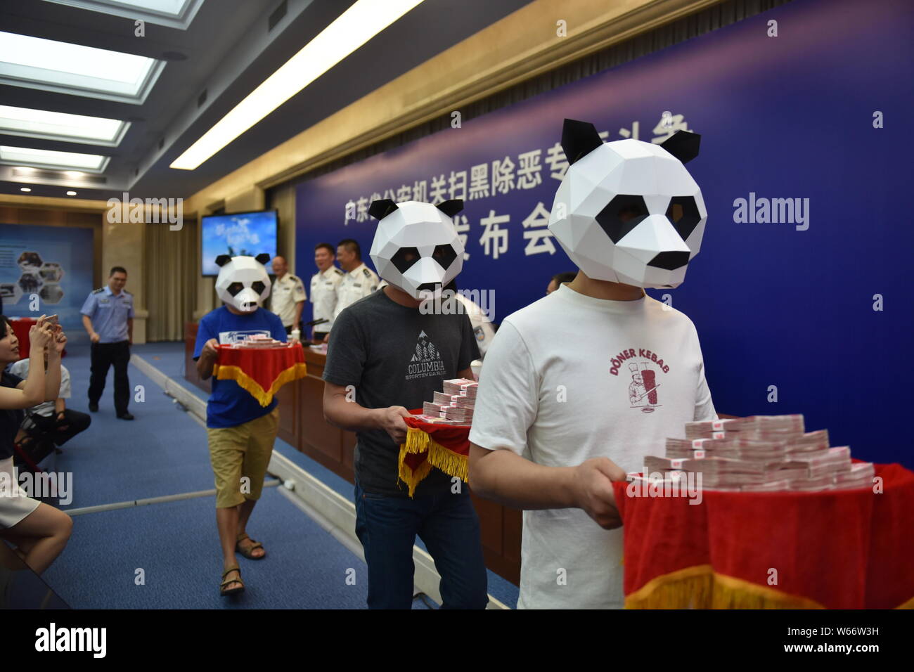 Three men with giant panda masks receive cash rewards for reporting ...