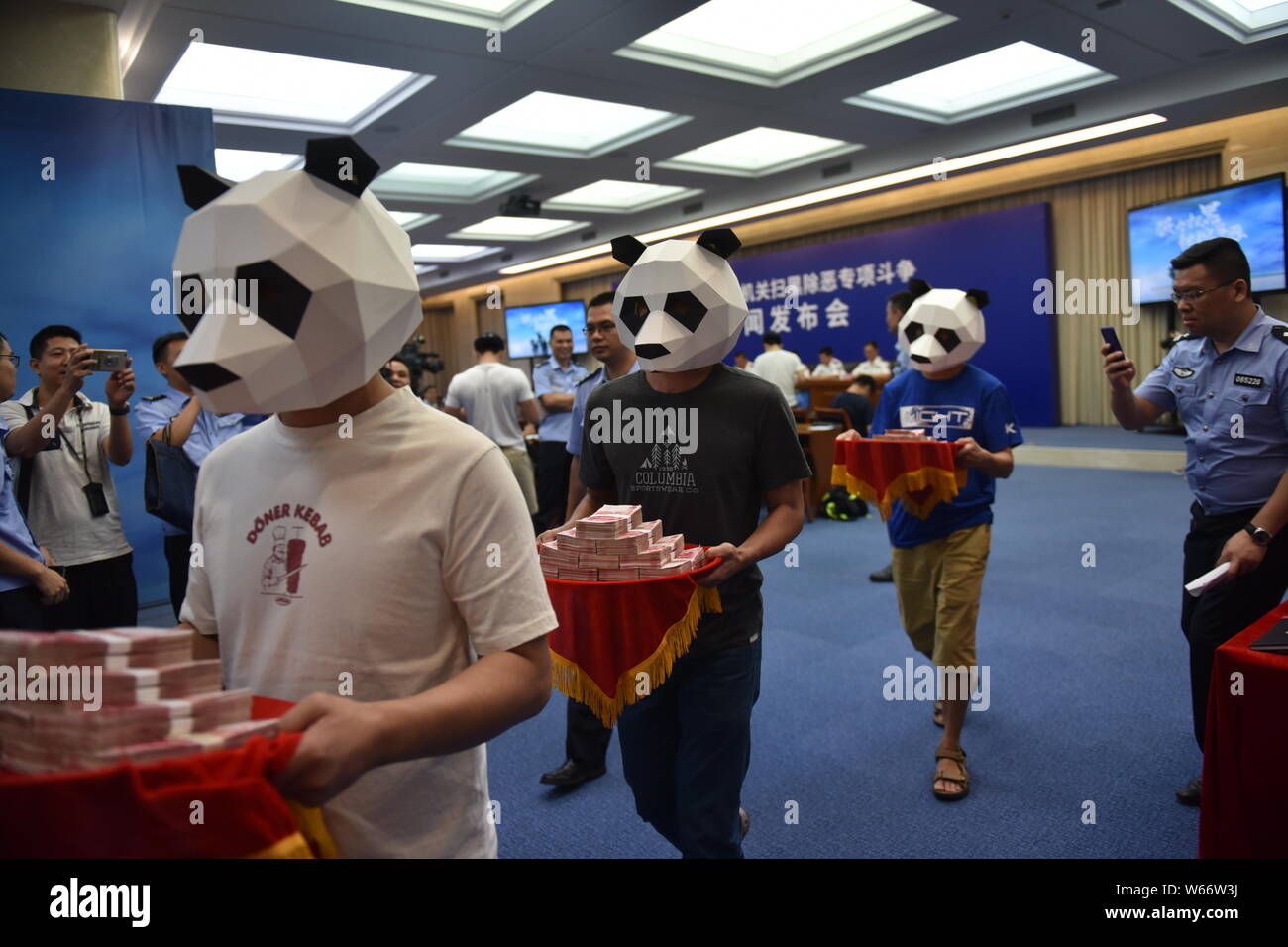 Three men with giant panda masks receive cash rewards for reporting ...