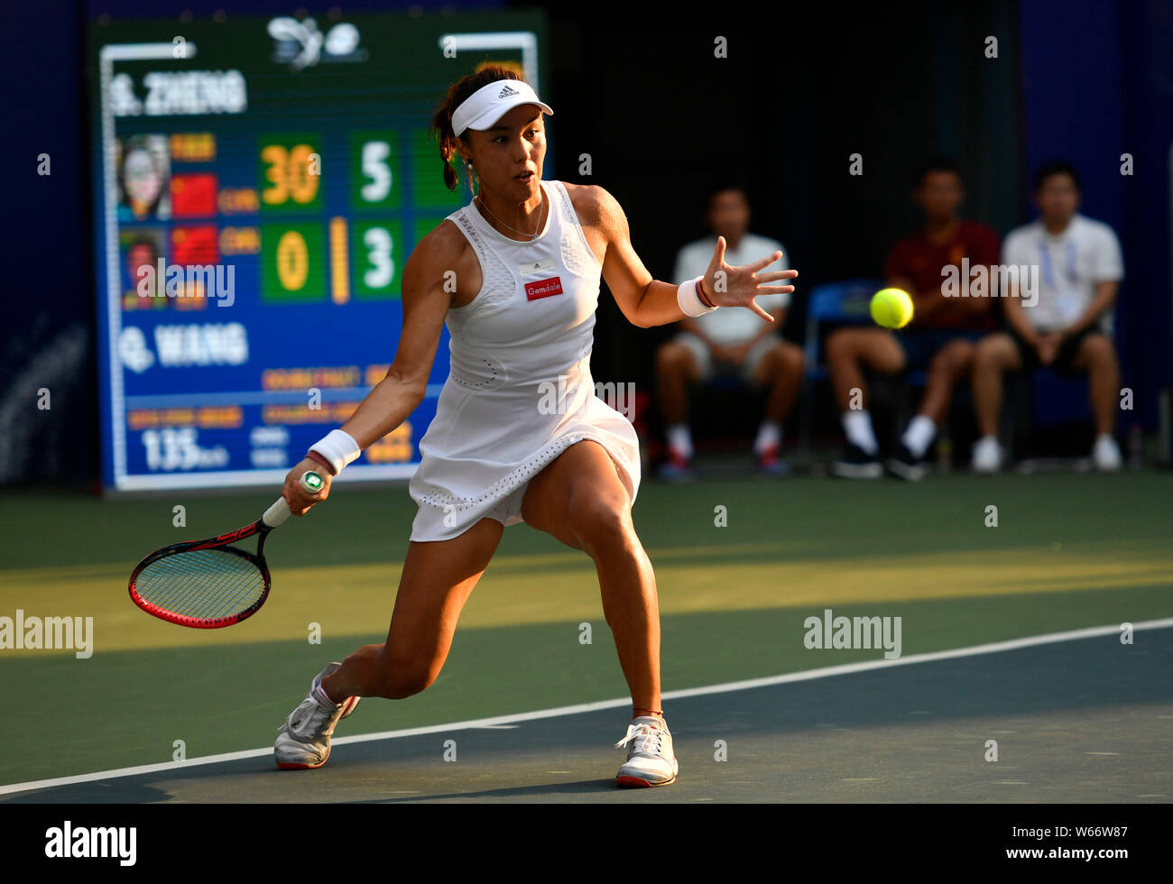 Wang Qiang of China returns a shot to Zheng Saisai of China in their ...