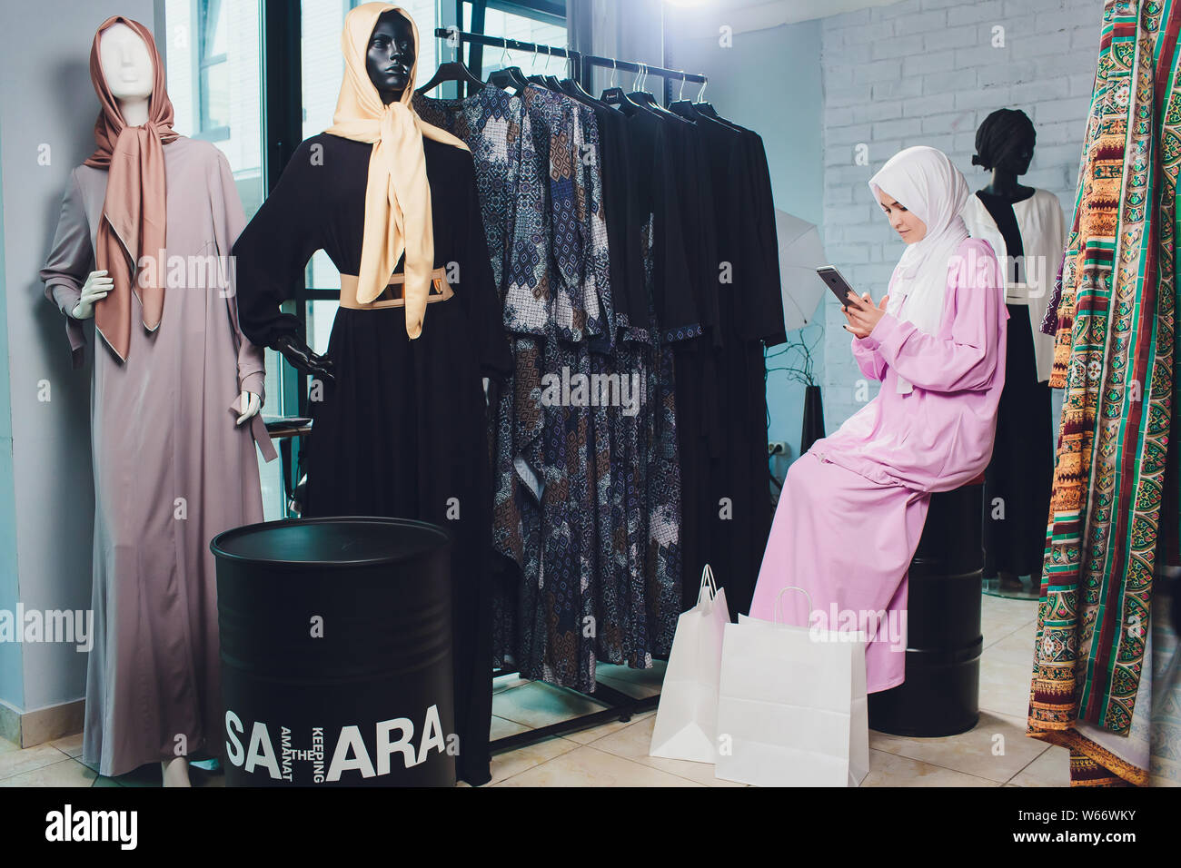 Arab woman in traditional Muslim clothes buys a new dress in an ...