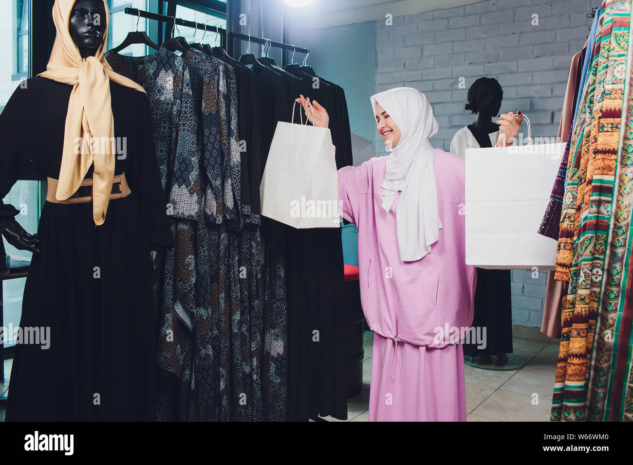 Arab woman in traditional Muslim clothes buys a new dress in an ...