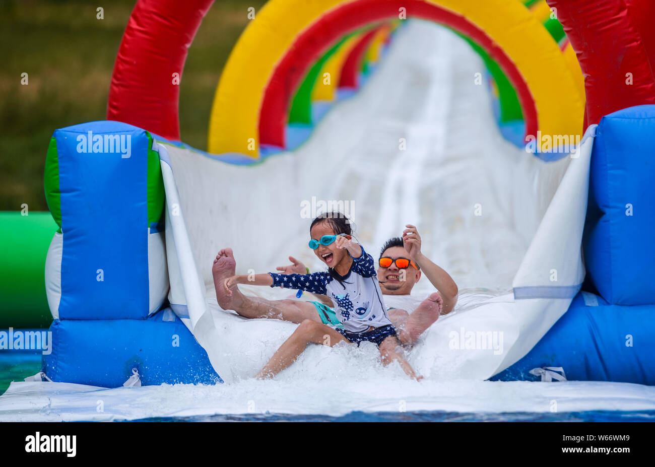 Tourists play on Asia's longest water slide at Jingzhihu Resort in ...
