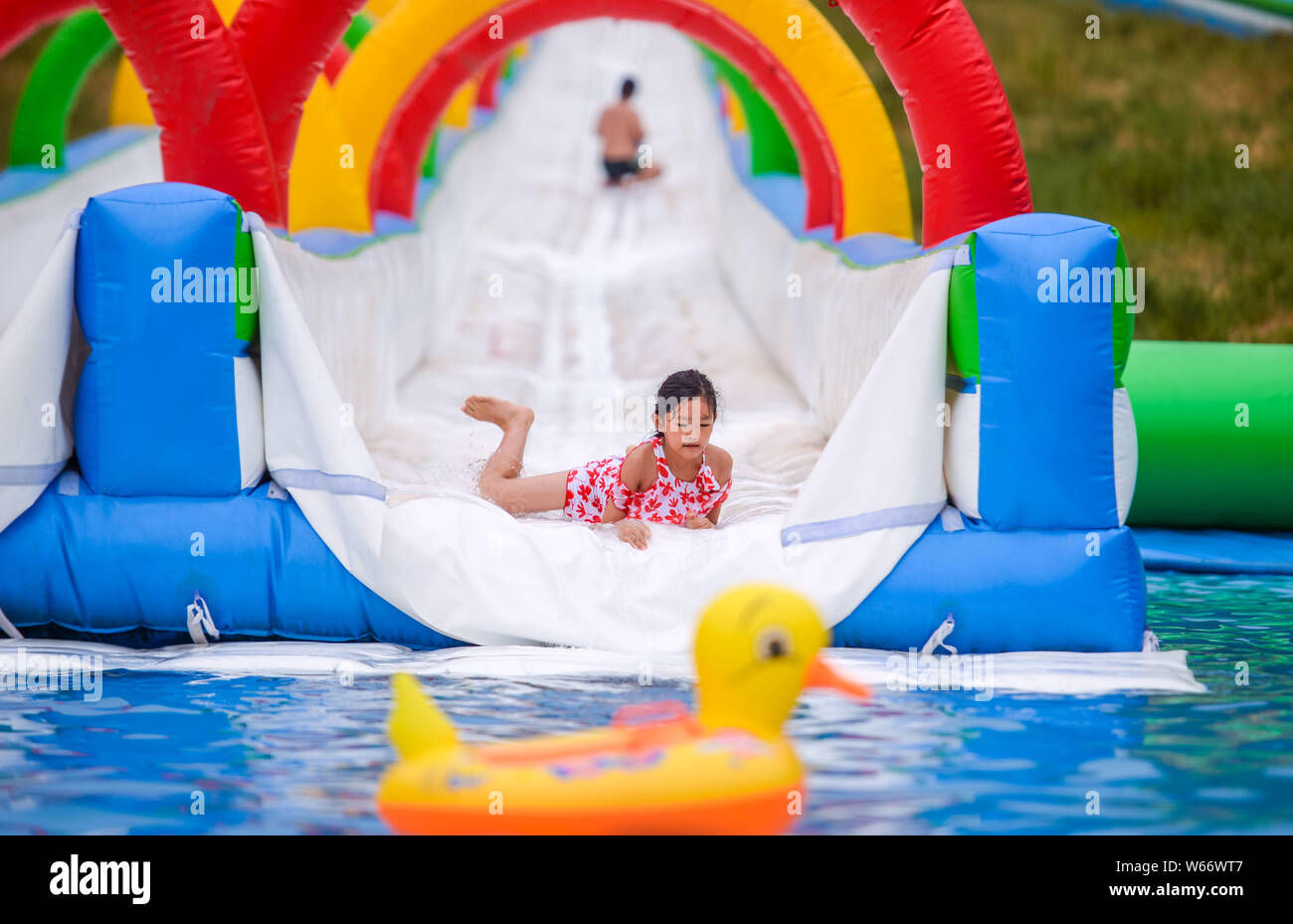 Tourists play on Asia's longest water slide at Jingzhihu Resort in ...