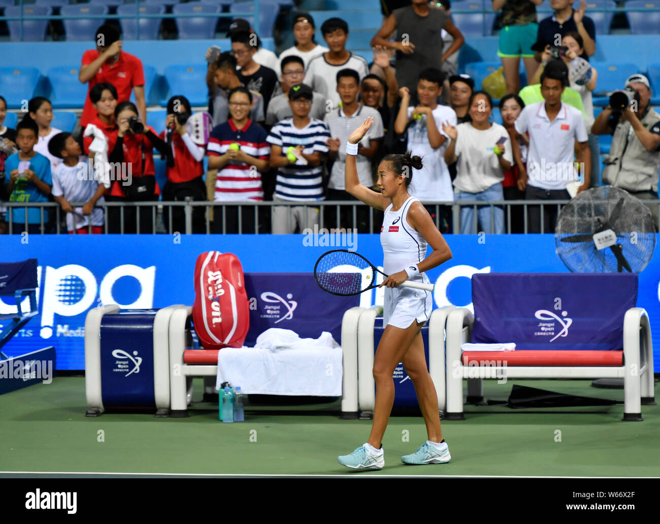 Zhang Shuai of China waves to fans after defeating Margarita Gasparyan ...