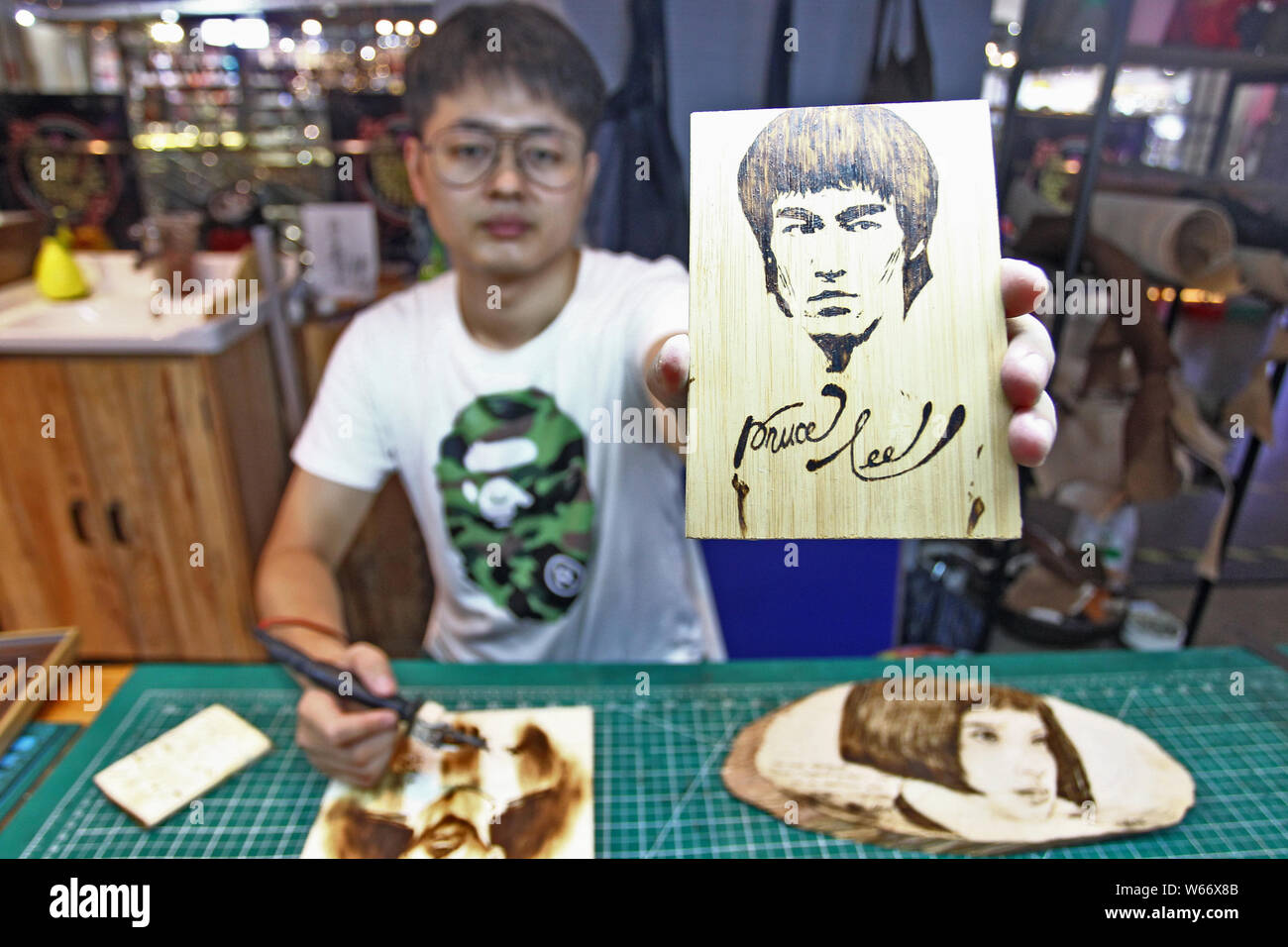 27-year-old Chinese man Peng Fang displays art works of pyrography at ...