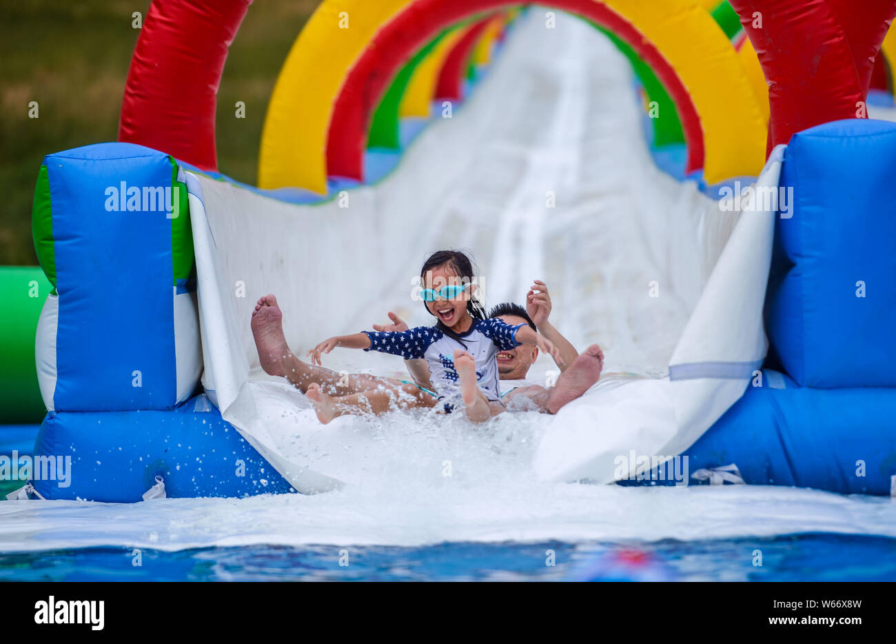 Tourists play on Asia's longest water slide at Jingzhihu Resort in ...