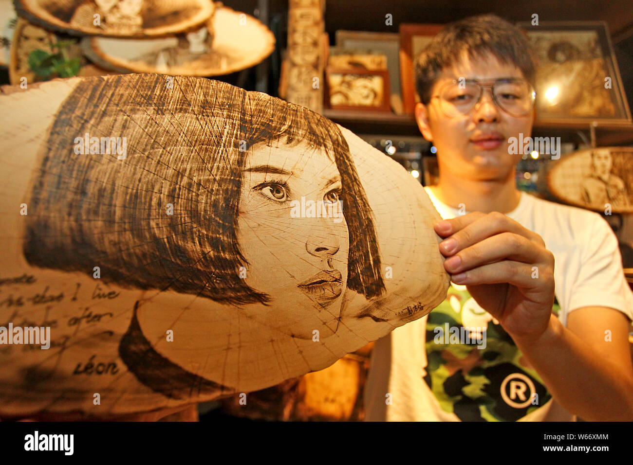 27-year-old Chinese man Peng Fang displays an art work of pyrography at ...